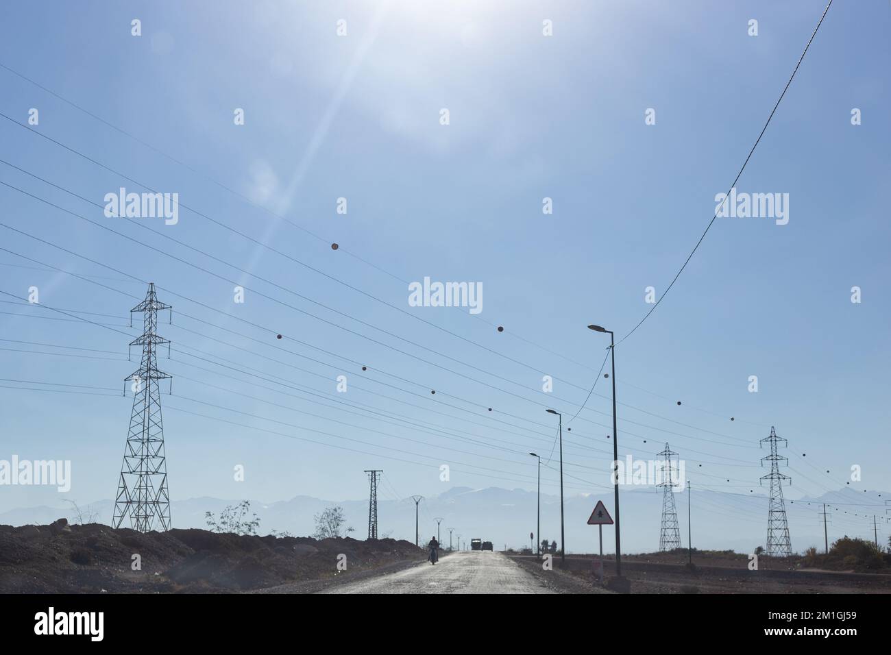 Rural road destroyed in the middle of high voltage pylons Stock Photo ...
