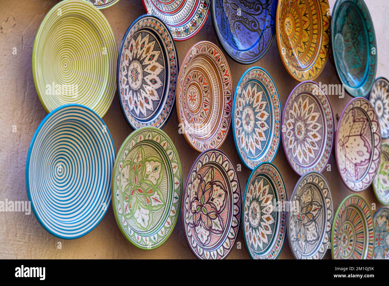 handmade clay plates hanging on the wall in a essaouira (sawira) market ...