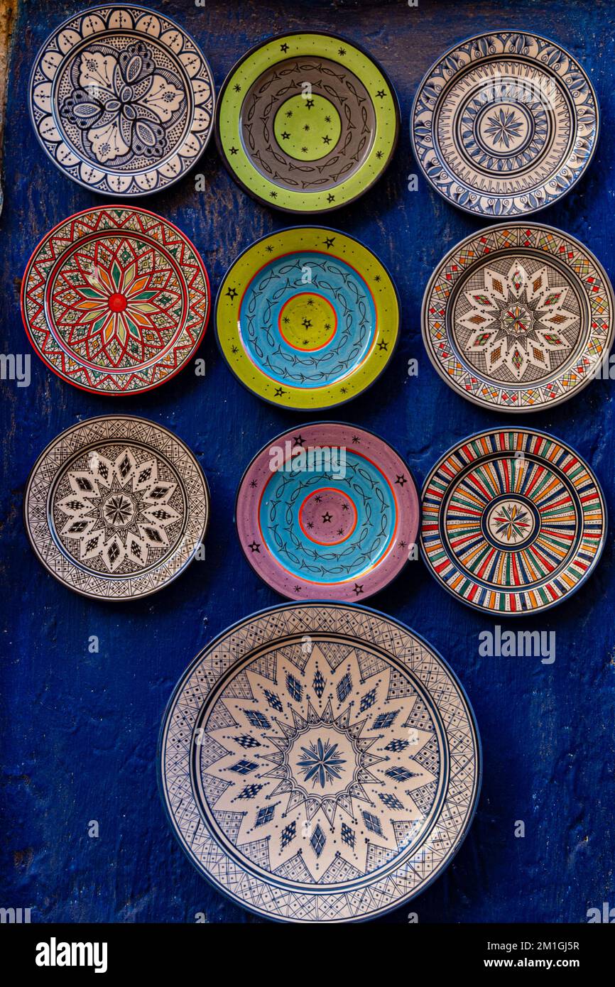 handmade clay plates hanging on the wall in a essaouira (sawira) market ...