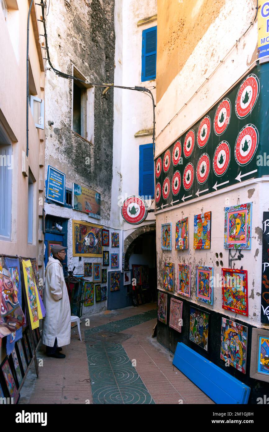 passerby admire the paintings hanging on the walls of the old city ...