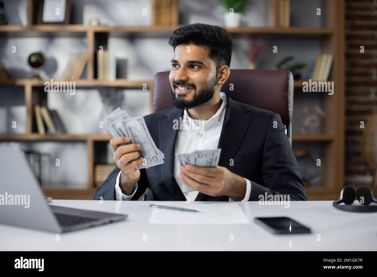 Rich business man working on laptop counting money cash, calculate ...