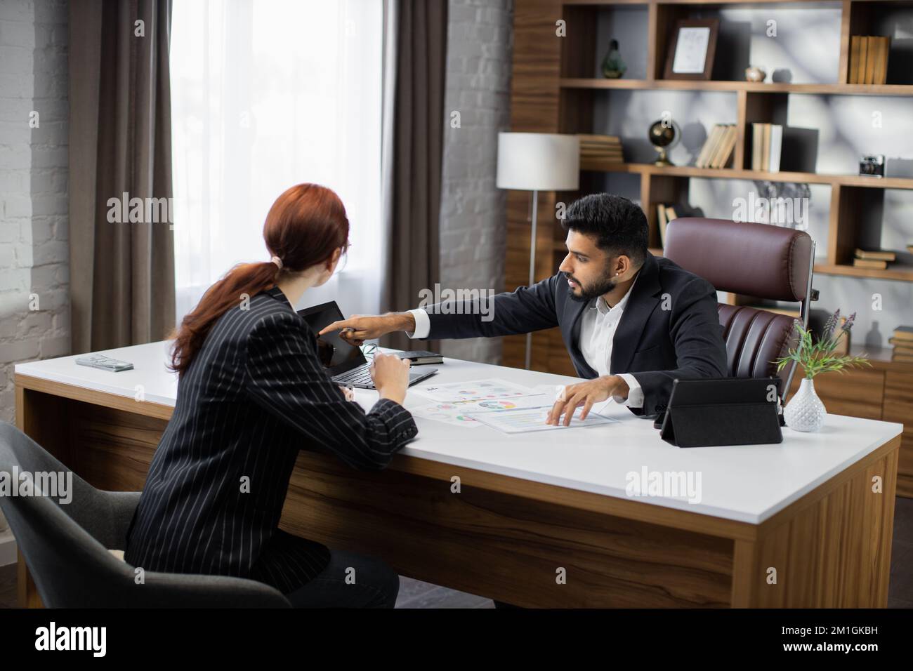 Businessman conducting an employment interview with an attractive young ...