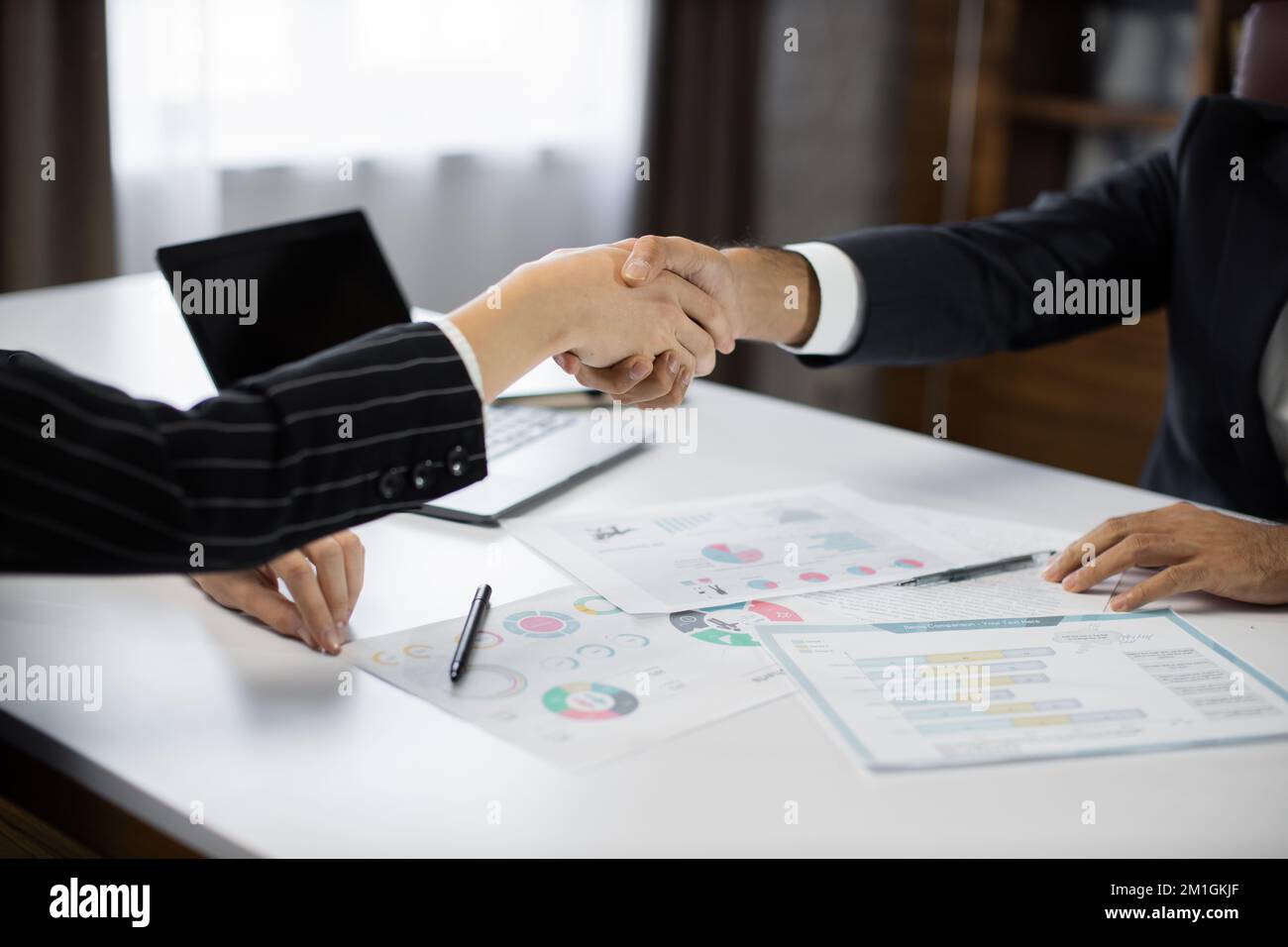 Close up of business partners handshake deal come to agreement ...