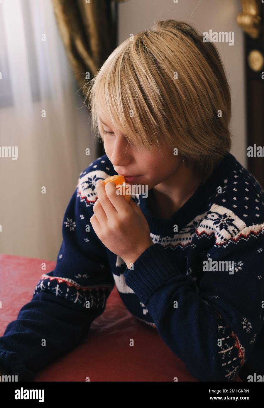 Boy eating mandarin hi-res stock photography and images - Alamy