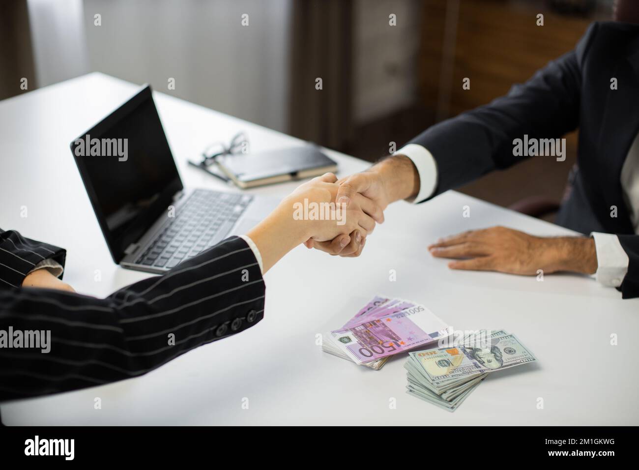 Close up of business partners handshake deal come to agreement ...