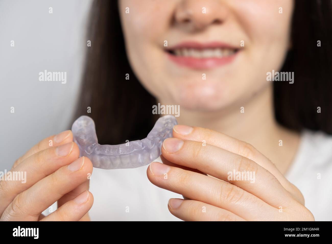 A Woman Holds Dental Mouthguard Splint For The Treatment Of
