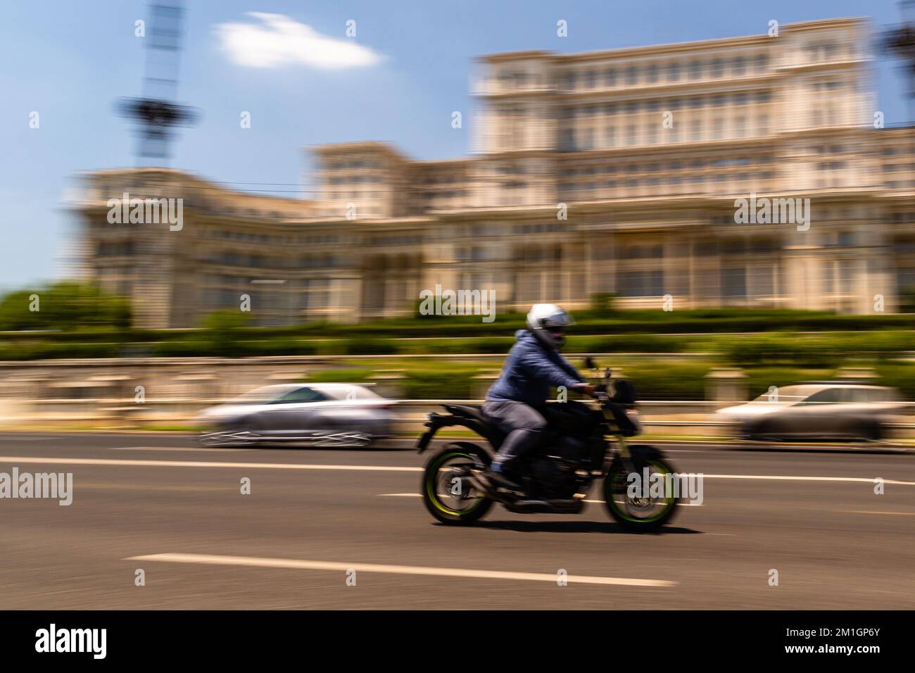 Biker on a motorcycle in traffic at rush hour in downtown area of the ...