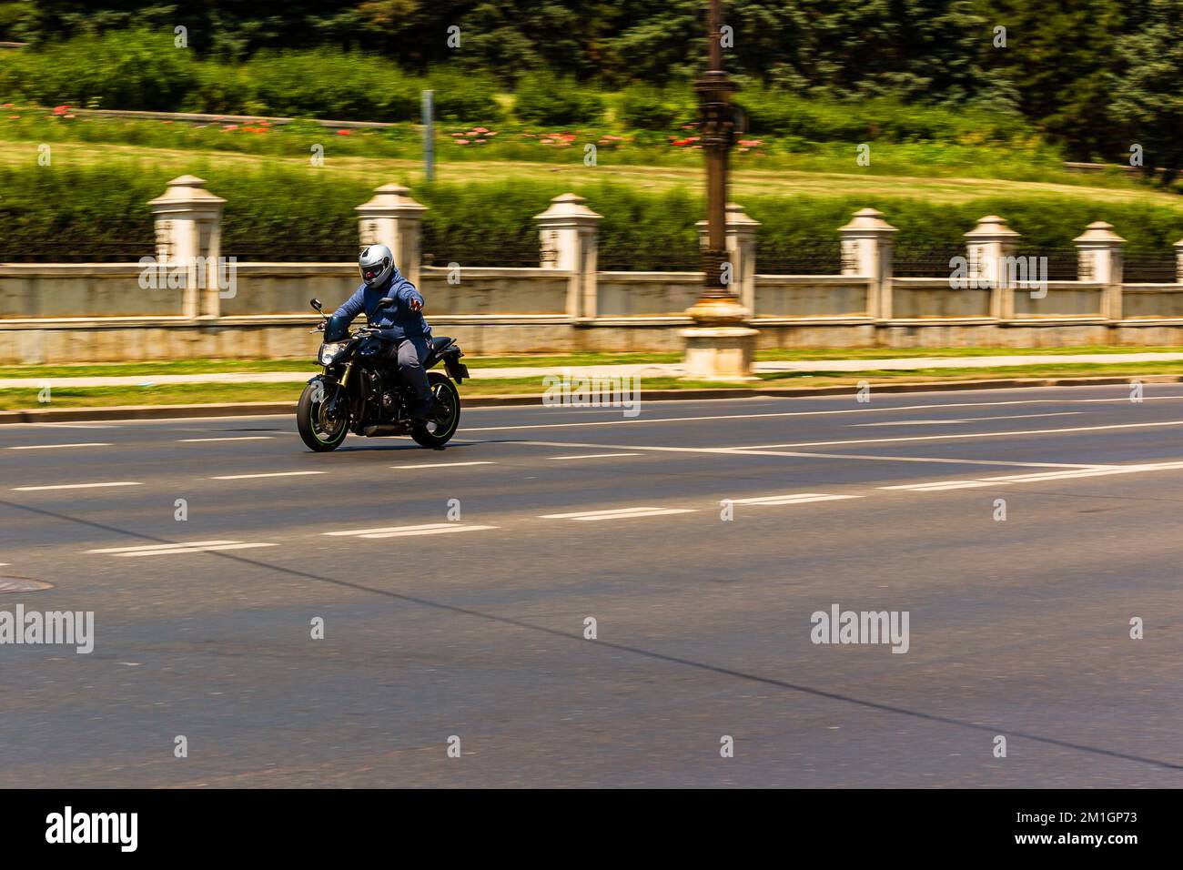 Biker on a motorcycle in traffic at rush hour in downtown area of the ...