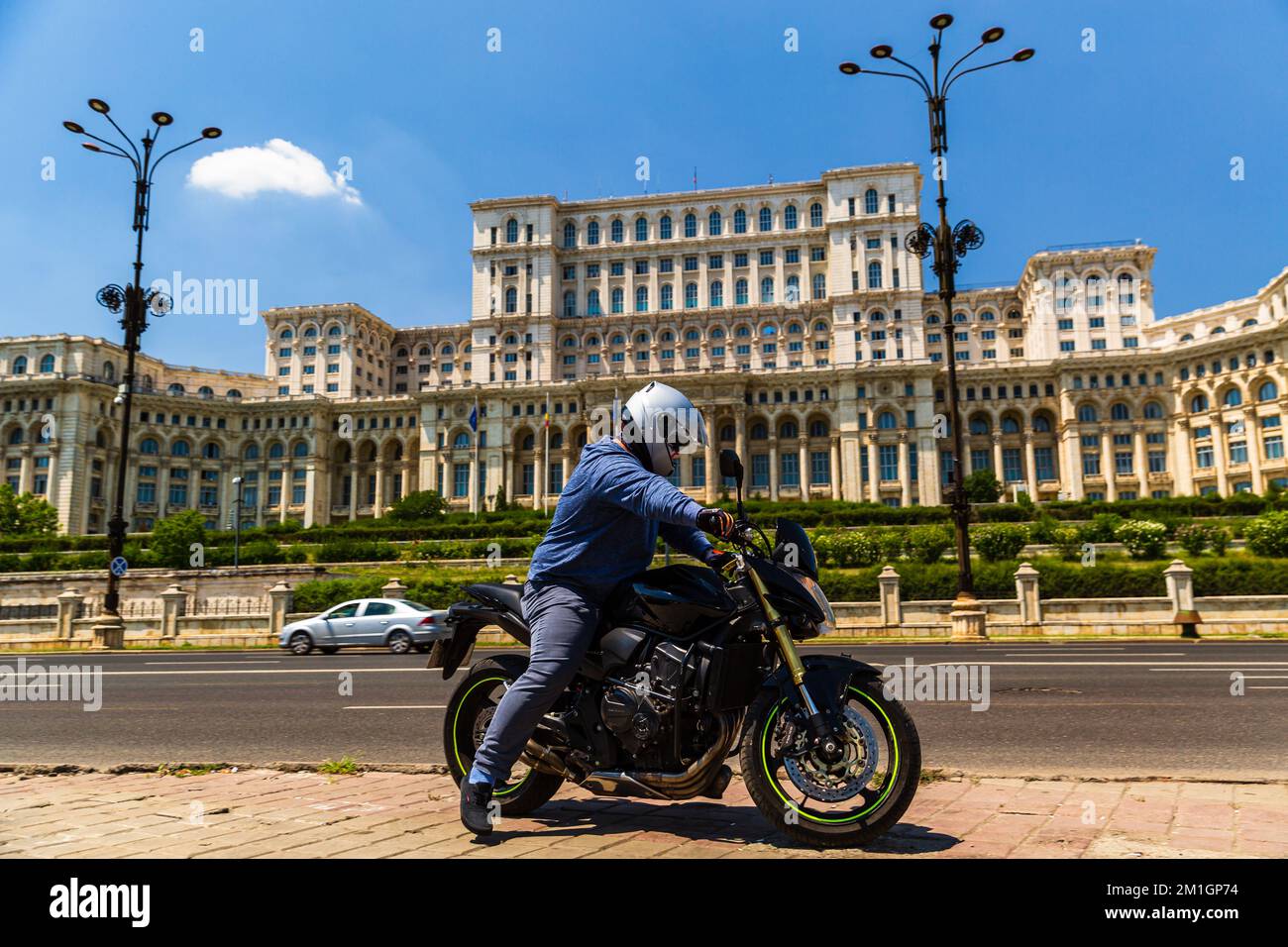 Biker on a motorcycle in traffic at rush hour in downtown area of the ...