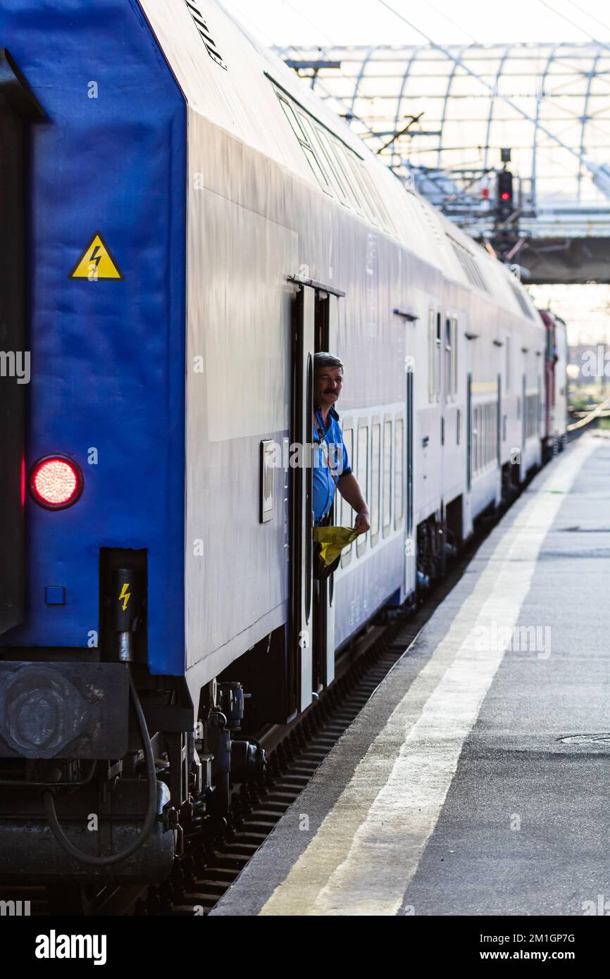 Railworker, train staff signaling for train conductor in Bucharest ...