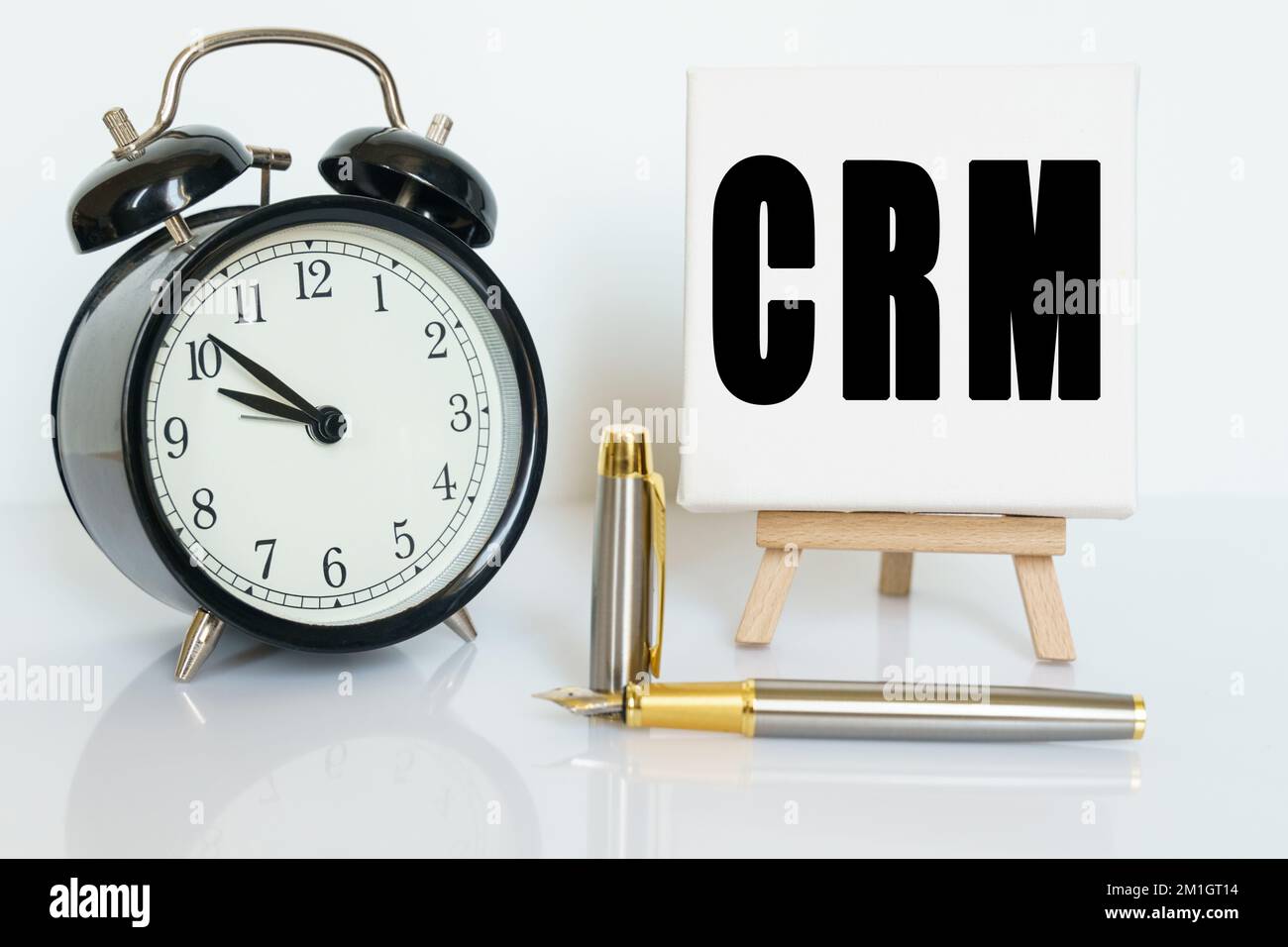 Business and finance concept. On the table there is a clock, a pen and ...