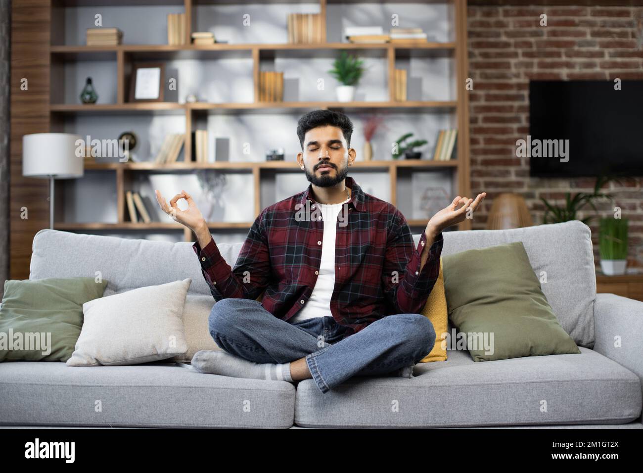 Calm of bearded young man doing yoga lotus pose to meditation and relax ...