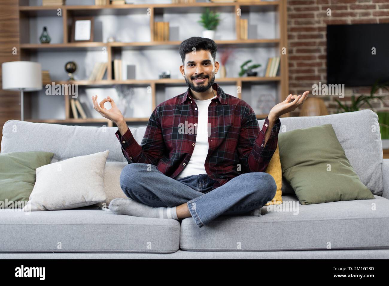 Calm of bearded young man doing yoga lotus pose to meditation and relax ...