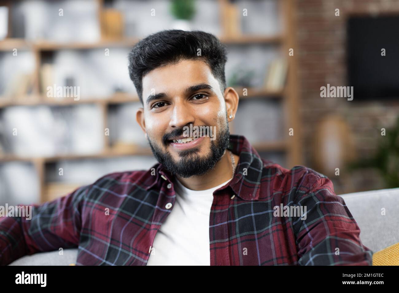 Close up portrait of handsome bearded man sitting, resting on ...
