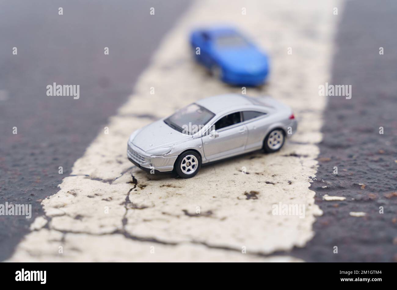 Incidents. Two cars are moving along a solid road marking line. One of ...