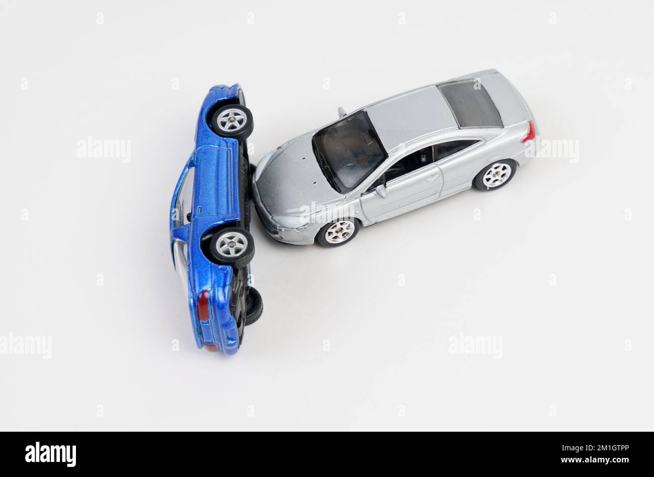 Occurrence. Collision of silver and blue toy cars. Isolated on white ...