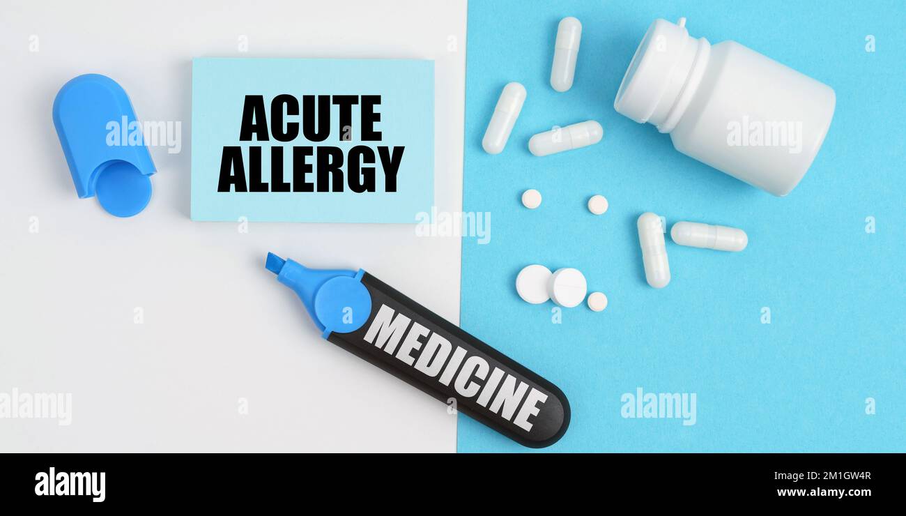 Medical concept. On the white and blue surface are pills, a marker and ...