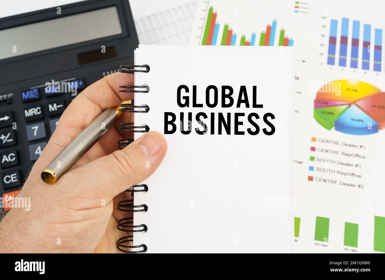 Finance and economics concept. The man is holding a pen and a notebook ...