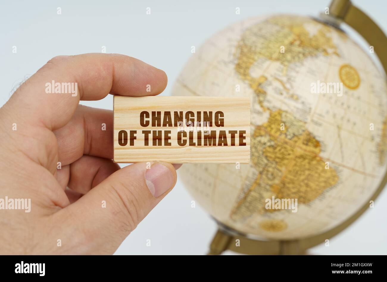 Globalization concept. A man holds in his hand a wooden plate on which ...