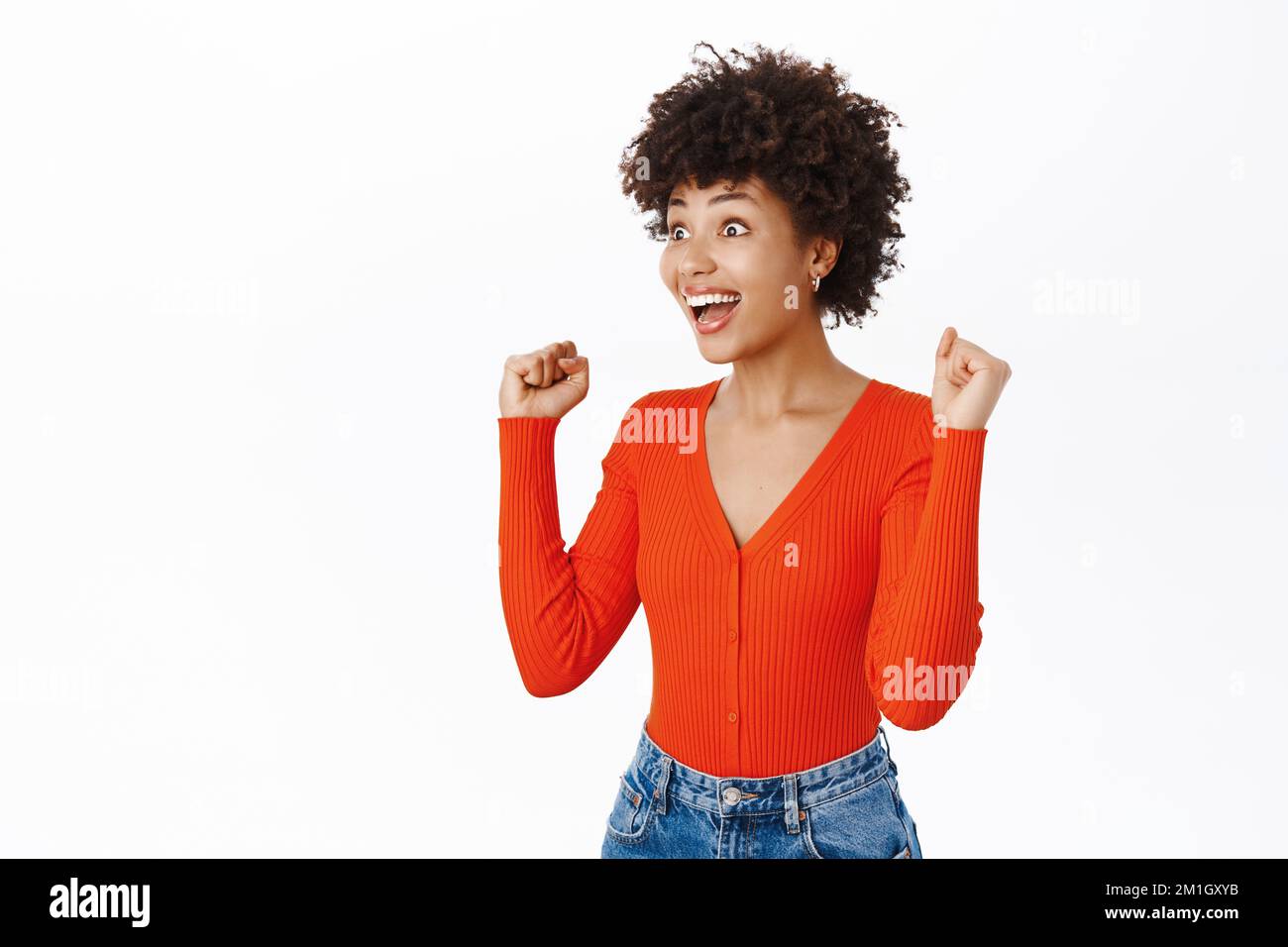 Image of african american girl looks excited, tempted to see smth ...