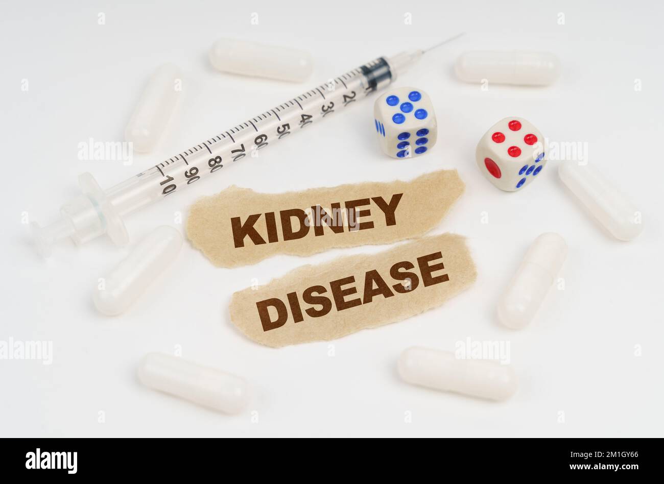 Medical concept. On a white surface lies a syringe, pills, dice and ...