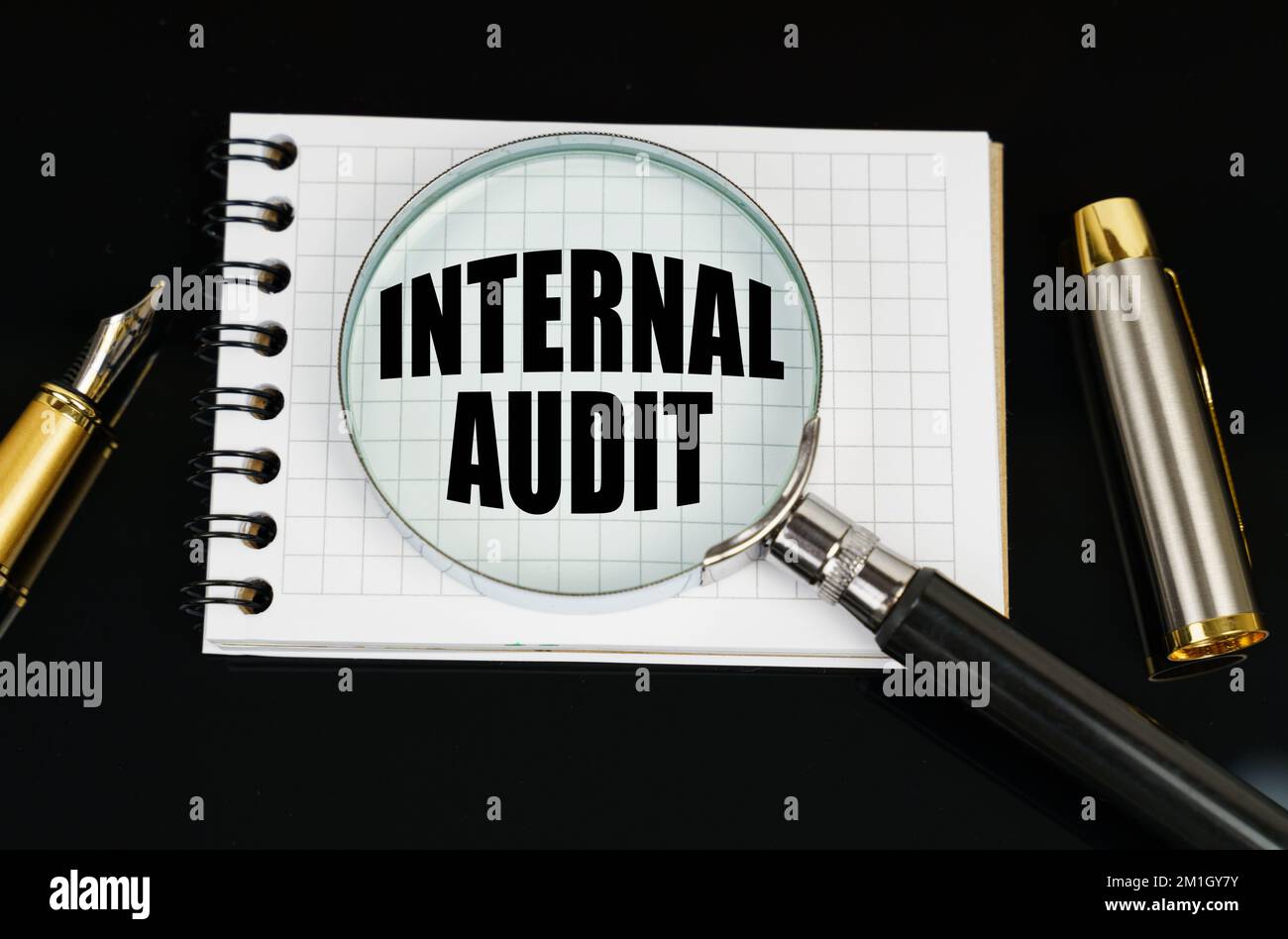 Business and finance concept. On a black surface there is a pen, a ...