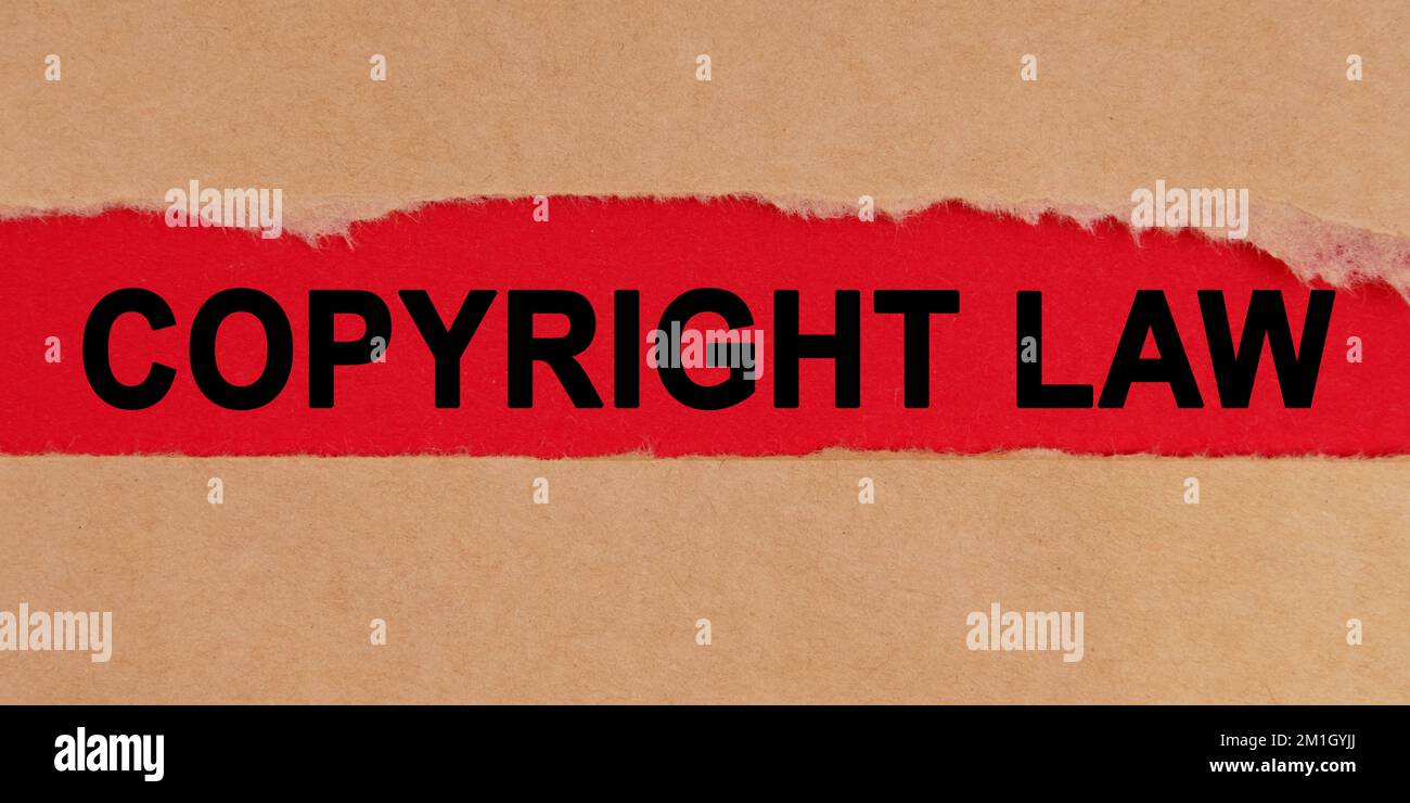 Law concept. Among the torn sheets of paper on a red background, the ...