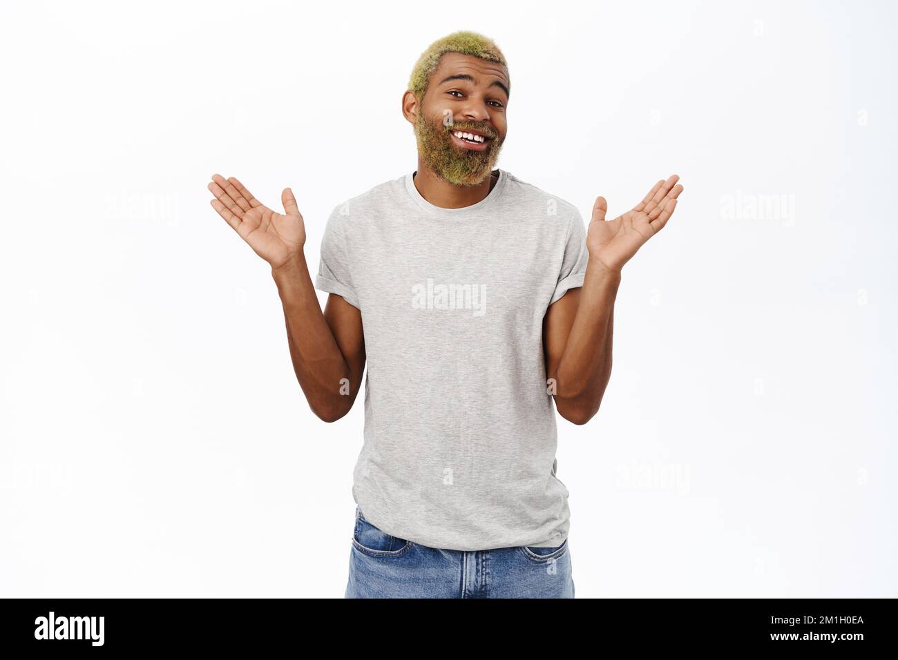 Handsome smiling african american man raising hands up, shrugs and ...
