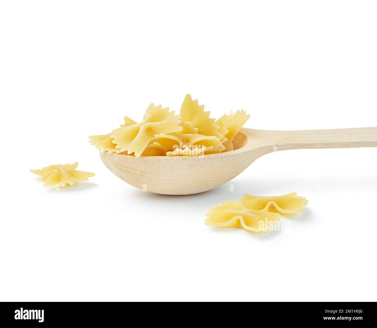 Raw pasta in wooden spoon on white background Stock Photo - Alamy