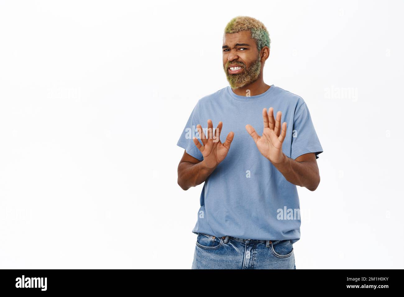 Disgusted guy rejects smth awful, looks with aversion and dislike ...