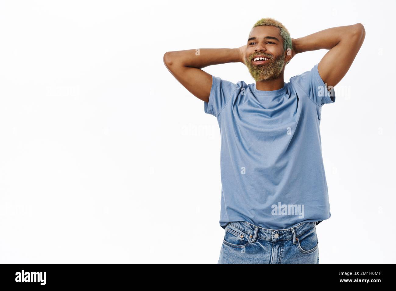 Portrait of handsome happy young man without worries, holds hands ...
