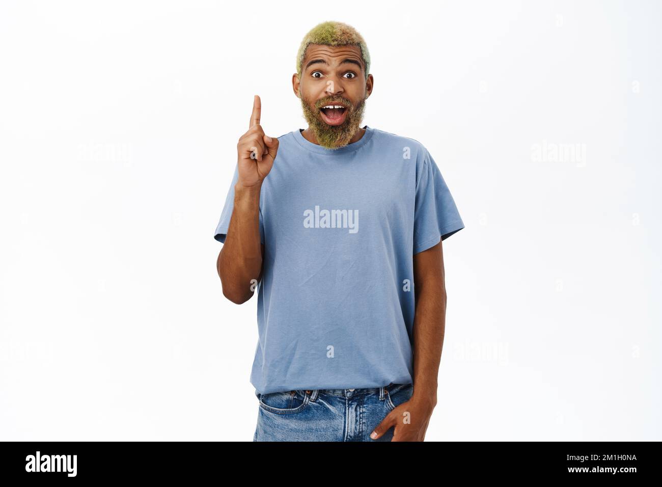 Enthusiastic Black guy points finger up, looks excited, has an idea ...