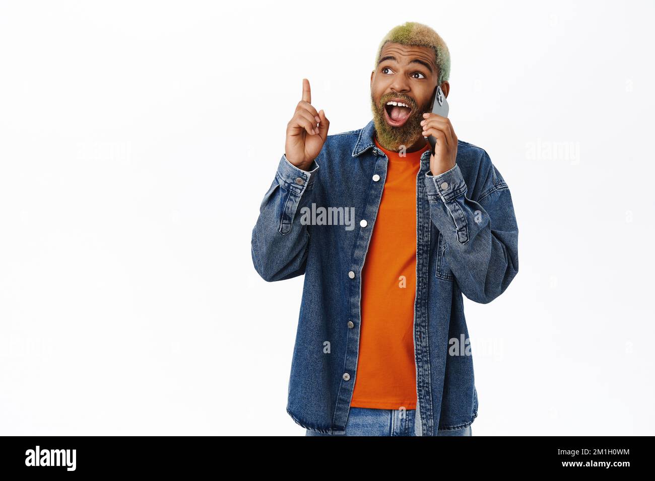 Enthusiastic guy calling someone, pitching an idea, pointing up ...