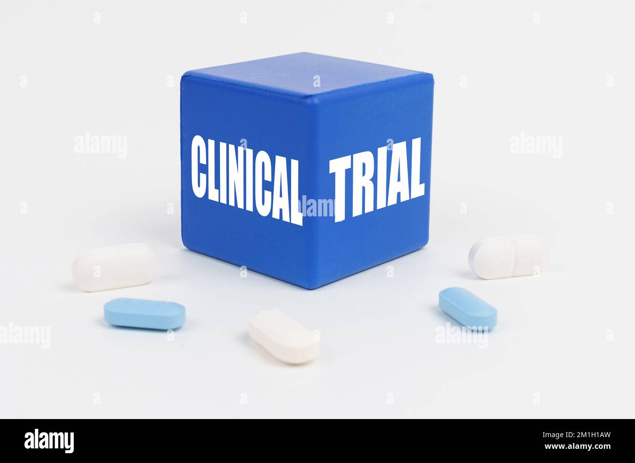 Medicine and health concept. On a white surface are pills and a blue ...