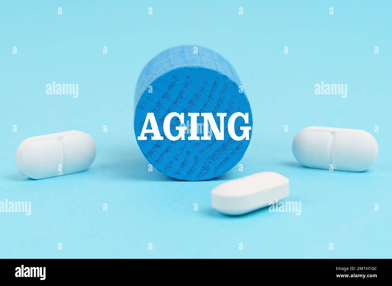 Medicine and health concept. Pills lie on a blue surface, a wooden blue ...