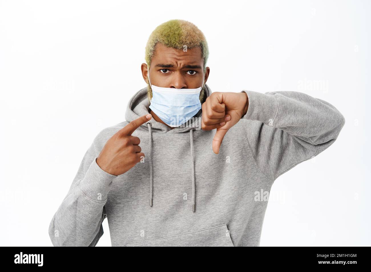 Covid 19, coronavirus concept. Black man shows wrong way of wearing ...