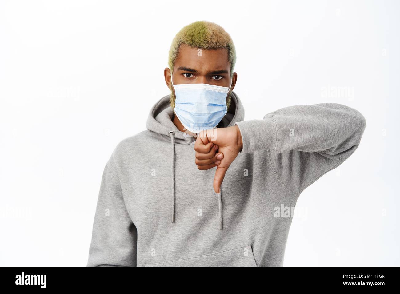 Covid 19, coronavirus concept. Upset african american man shows thumbs ...