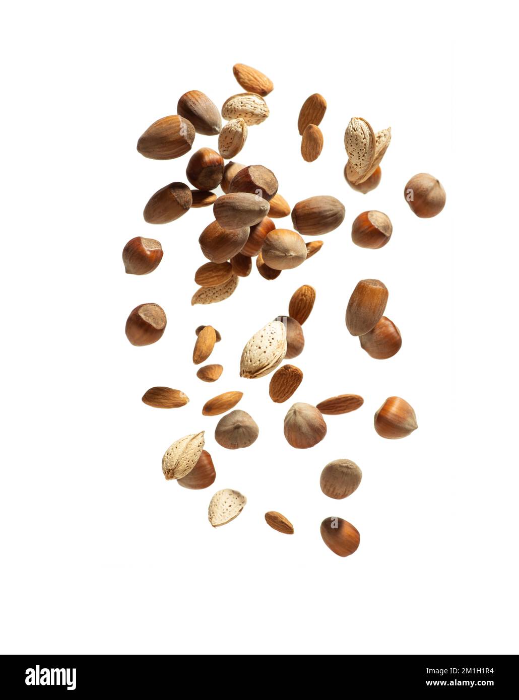 Different nuts falling on a white isolated background Stock Photo - Alamy