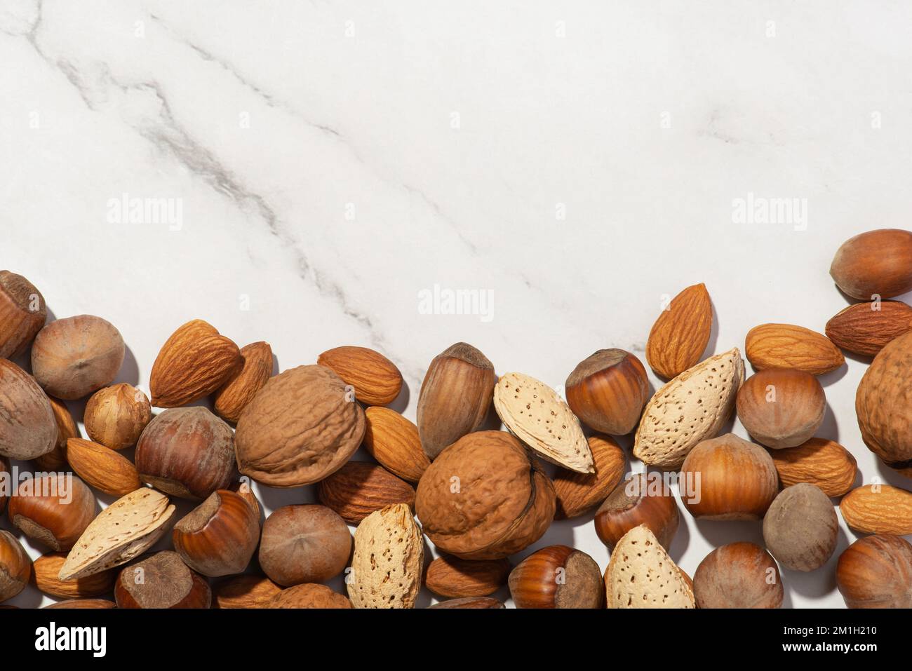 Background with different nuts on a white background Stock Photo - Alamy