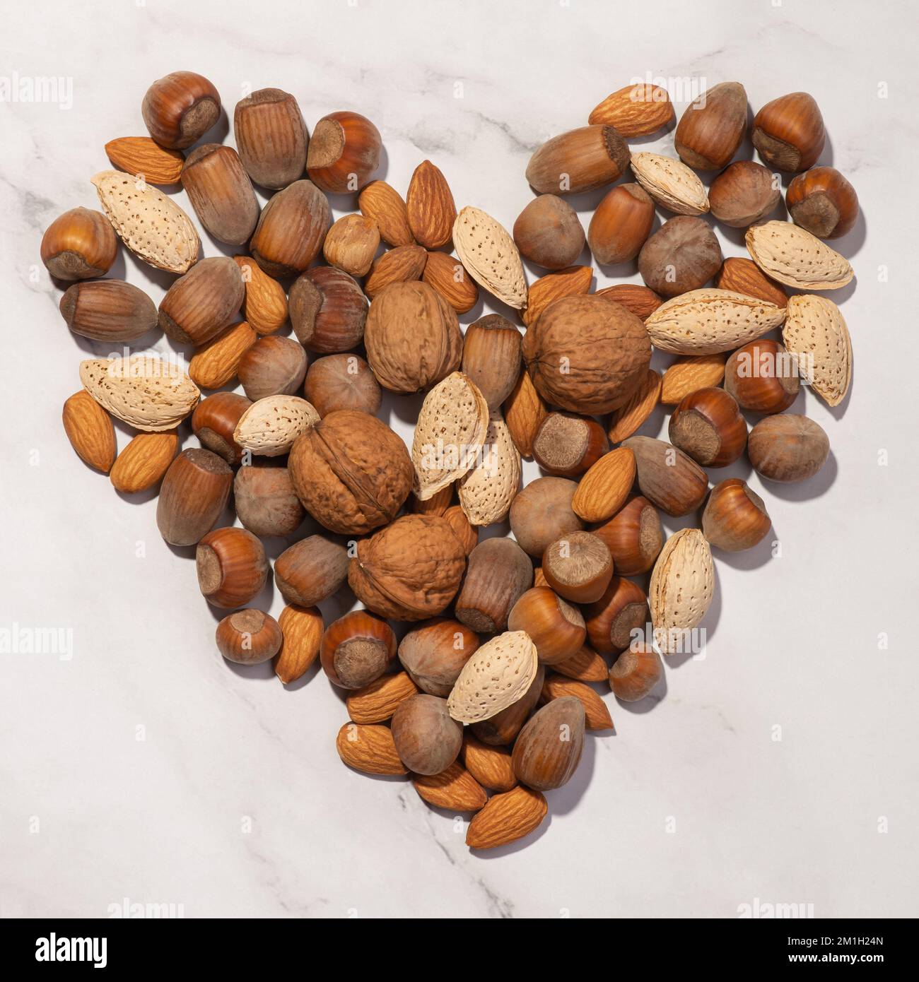 Almond nuts on heart hi-res stock photography and images - Alamy