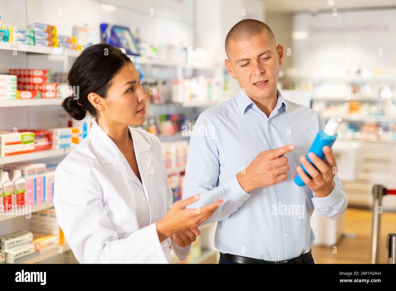 Asian pharmacist helping client hi-res stock photography and images - Alamy