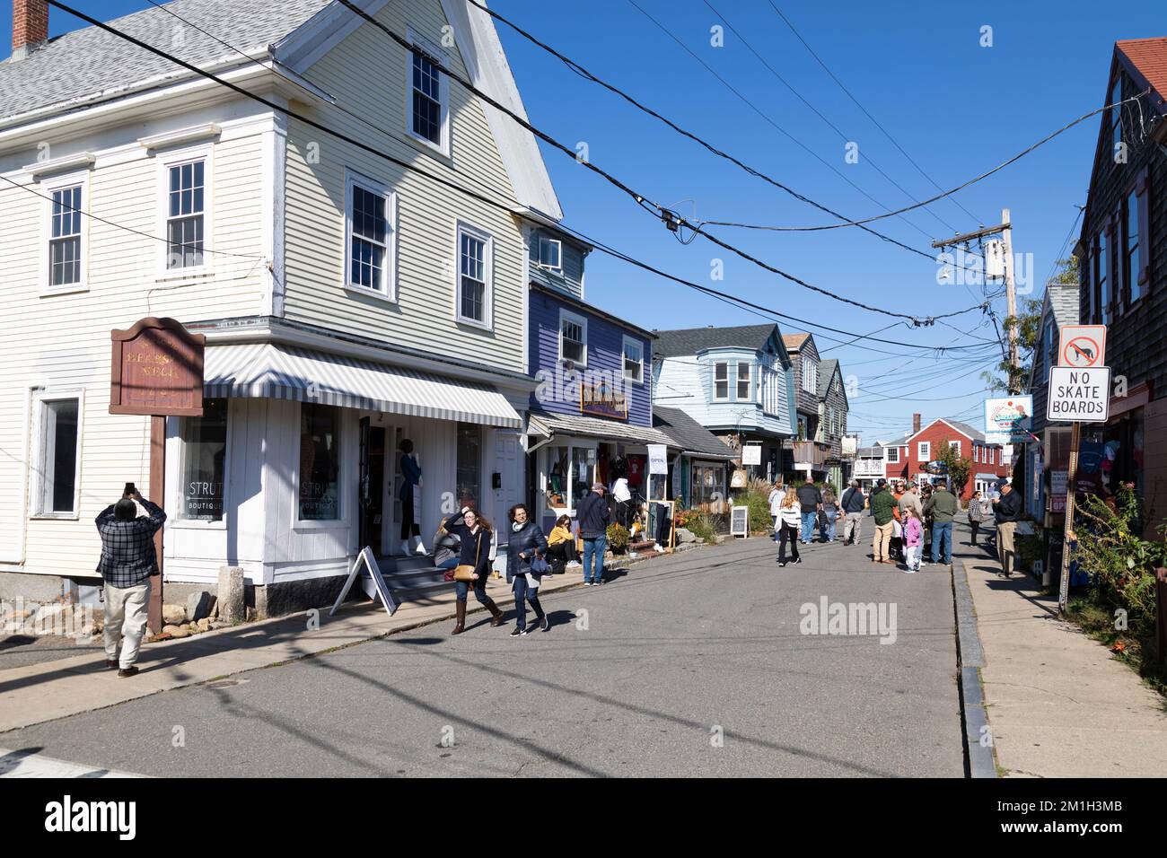 People stroll around the unique shops and boutiques on Bearskin Neck in ...