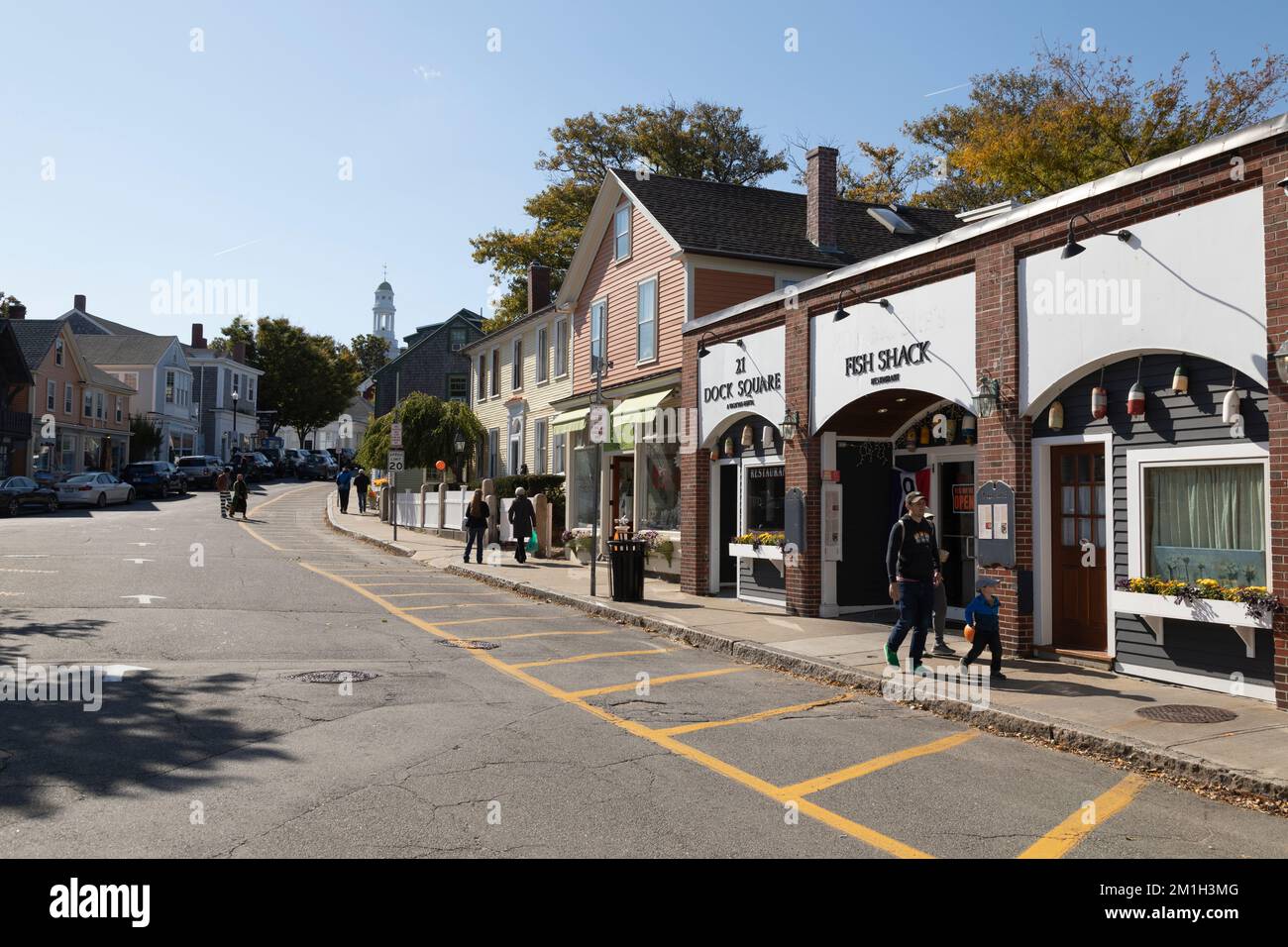 People stroll around the unique shops and boutiques on Bearskin Neck in ...