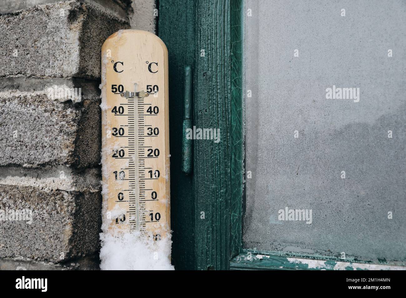 Snow covered outdoor thermometer on windowsill. Winter, weather ...