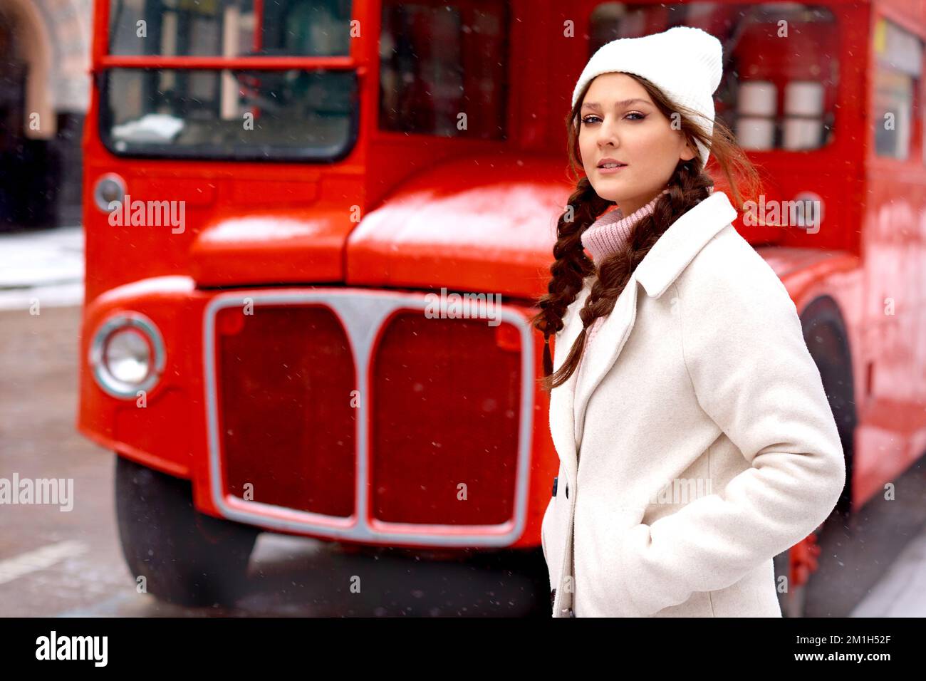 woman cross the road. teenage student stands at the bus stop and waits ...