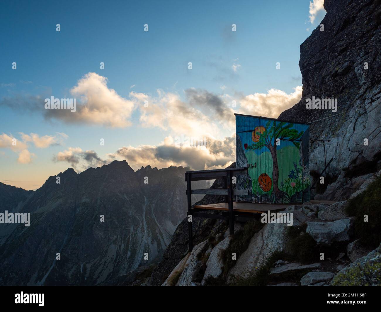 The wooden toilet of the Rysy mountain during sunset clouds Tatra ...