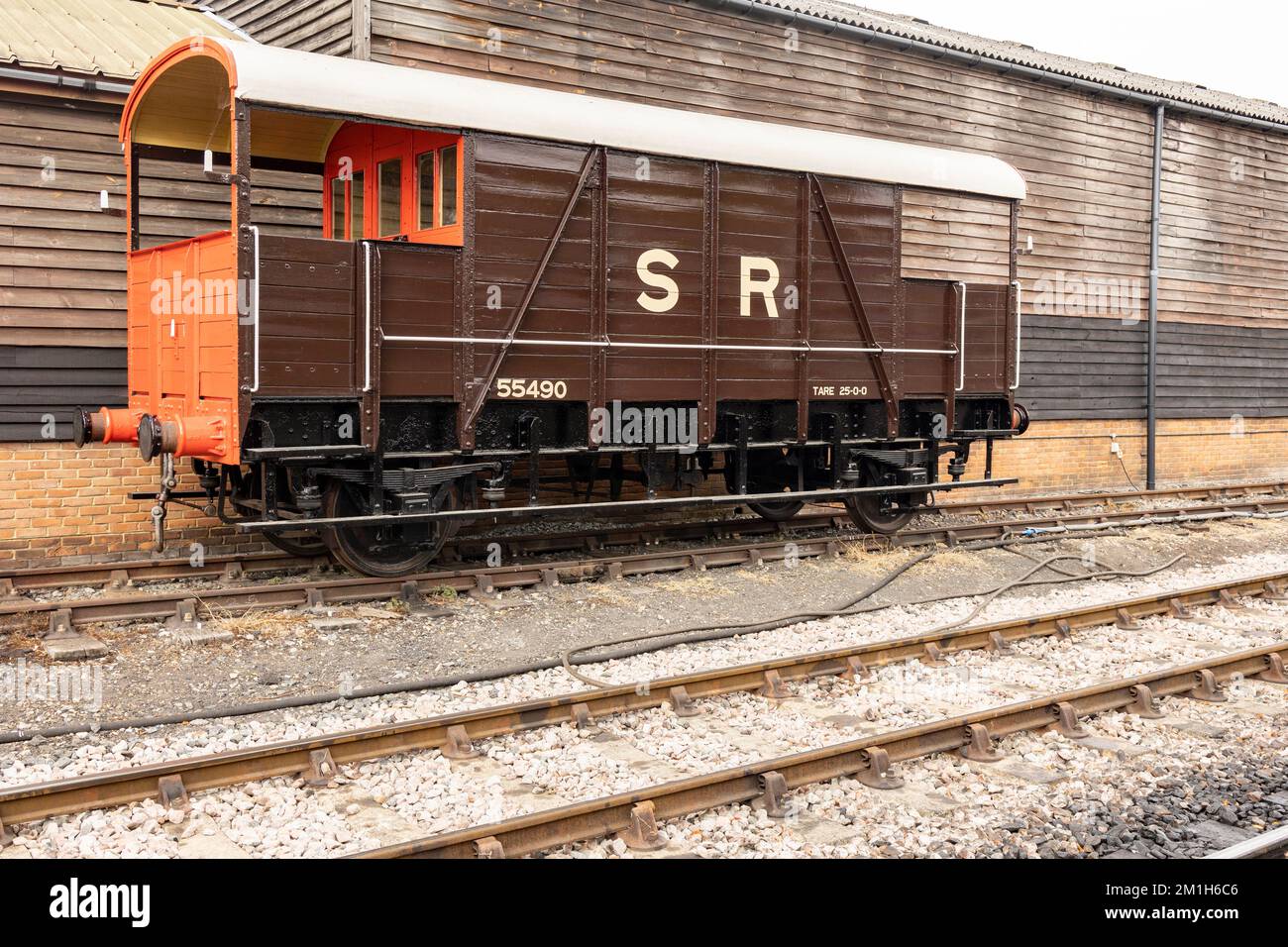 An old passenger railway car with peeling paint on the carriage of the ...