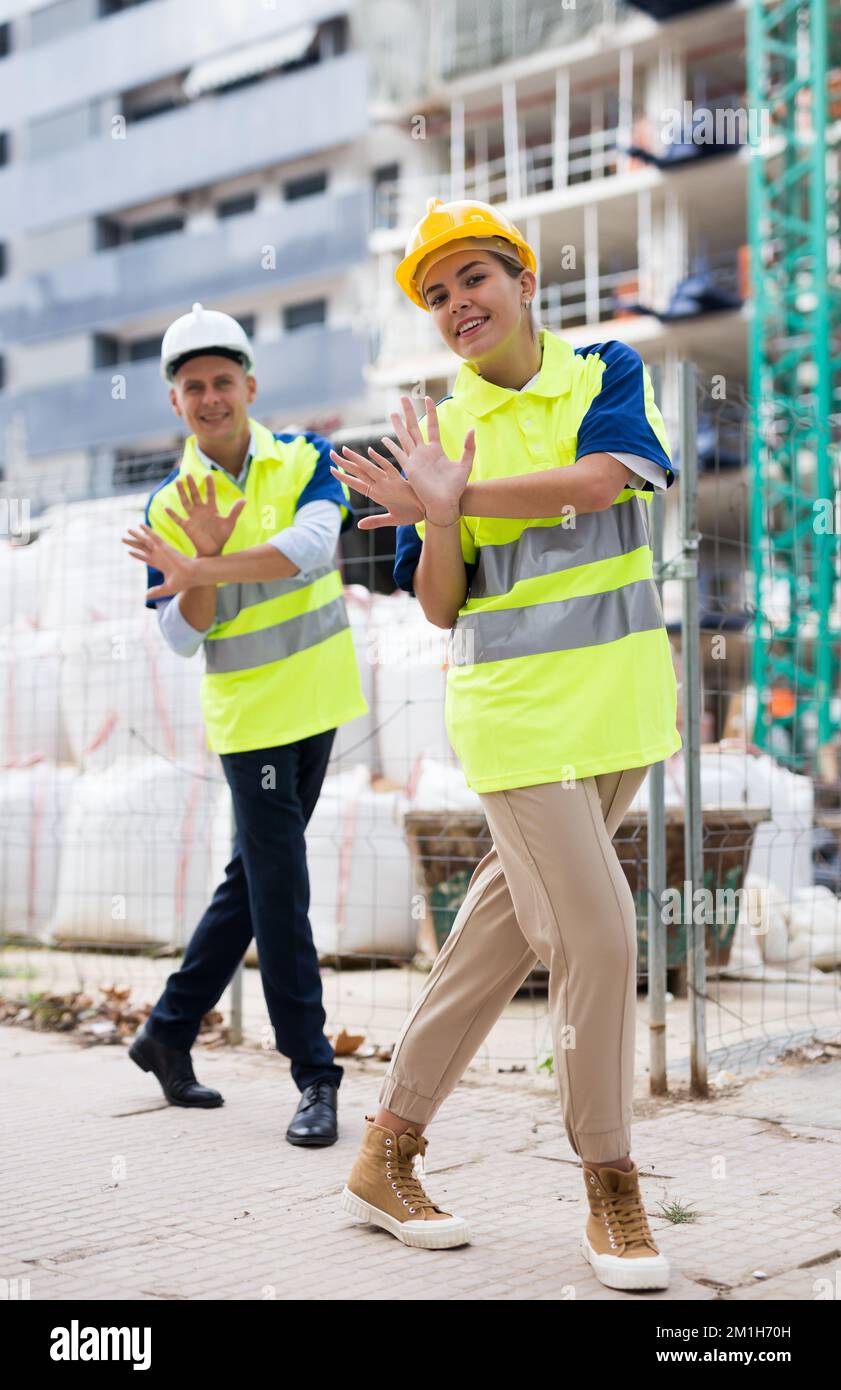 Builders dancing in construction site Stock Photo - Alamy