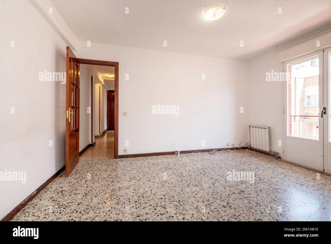 An empty room with access to others with wooden doors leading to a ...