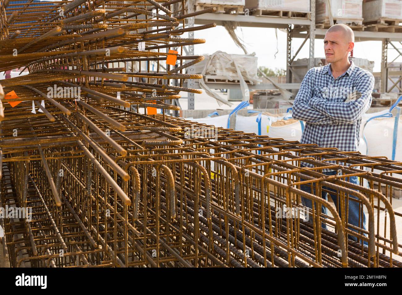 Man worker with reinforcing steel bars during work in warehouse Stock ...